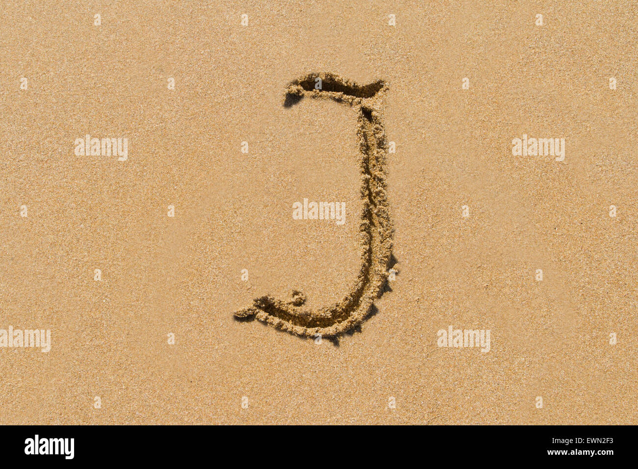 Letter J of the alphabet written on sand with upper case Stock Photo ...