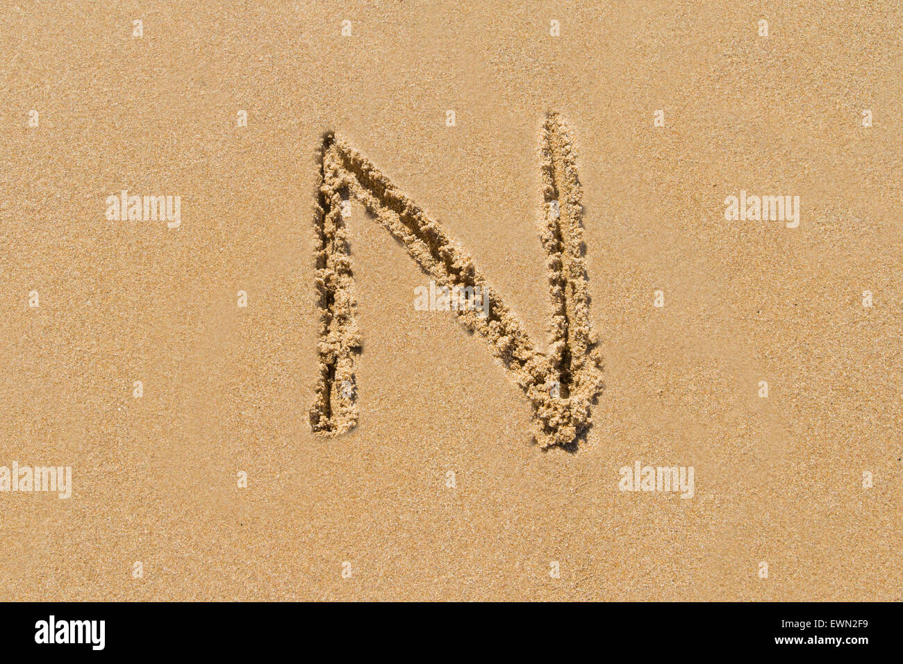 Letter N of the alphabet written on sand with upper case Stock Photo ...