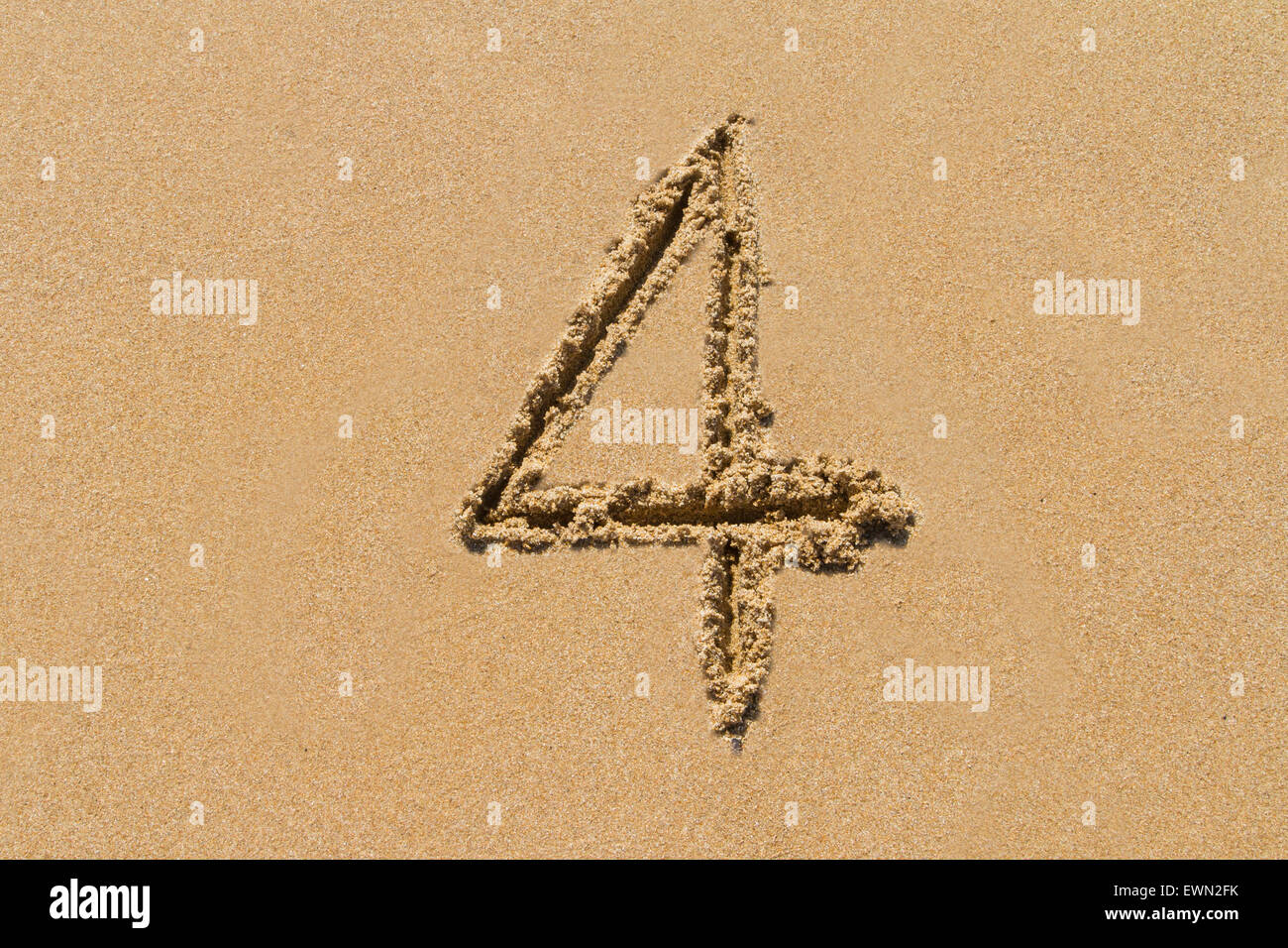 The number 4 drawn on sand at the beach, holiday concept background ...