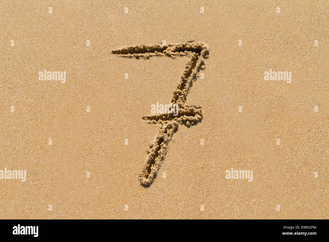The number 7 drawn on sand at the beach, holiday concept background ...