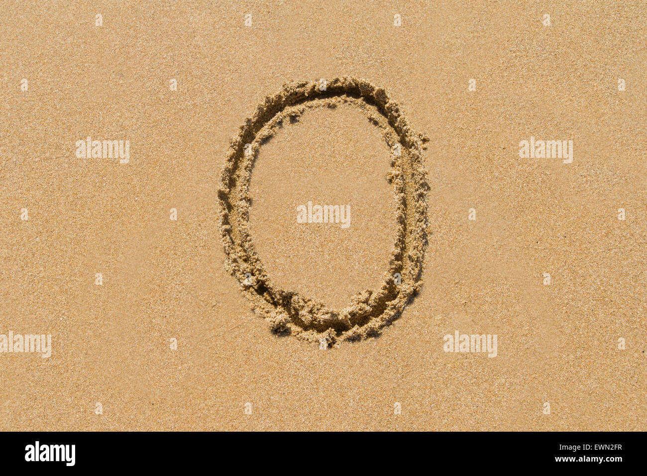 The number 0 drawn on sand at the beach, holiday concept background ...