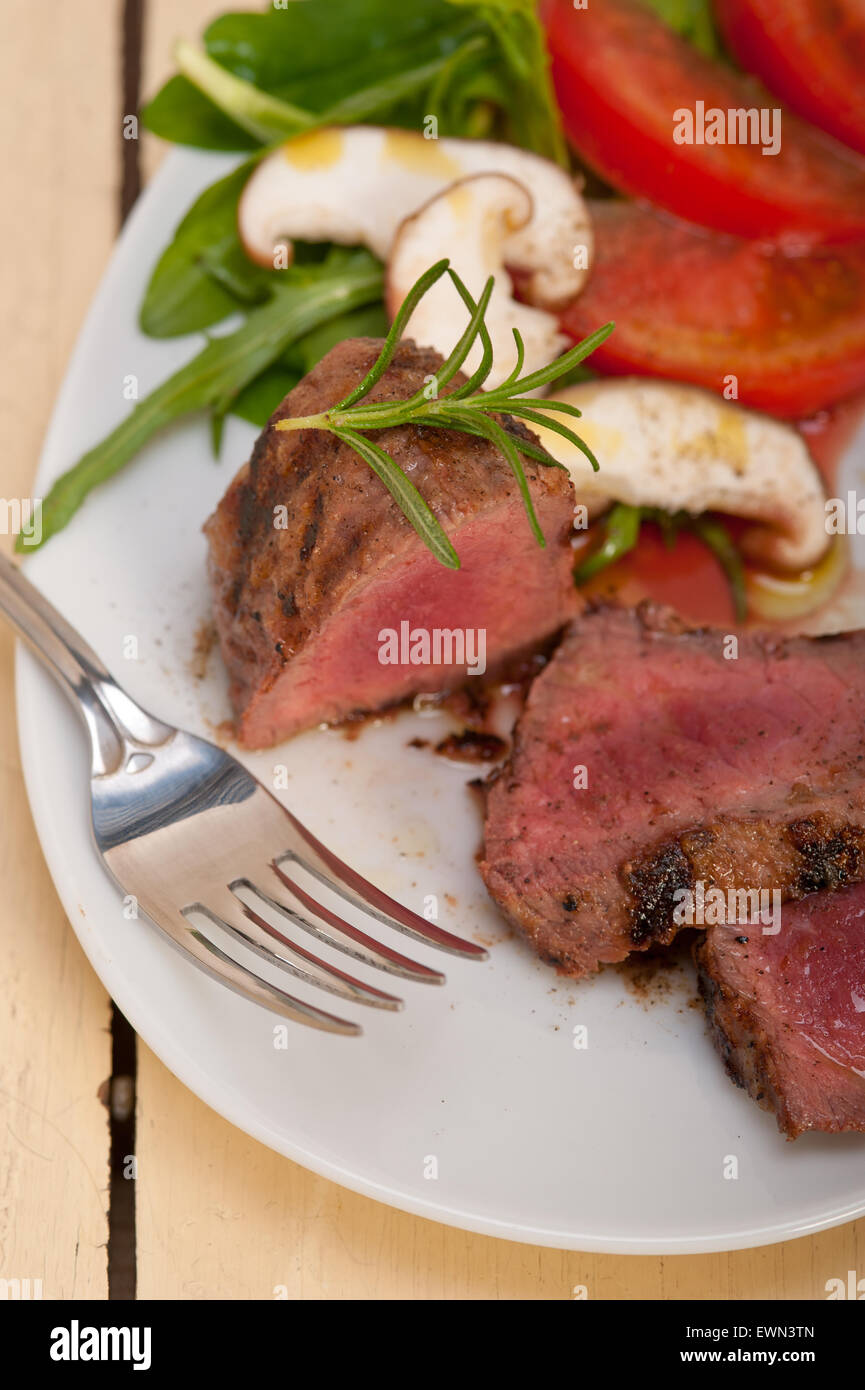beef filet mignon grilled with fresh vegetables on side ,mushrooms tomato and arugula salad ...