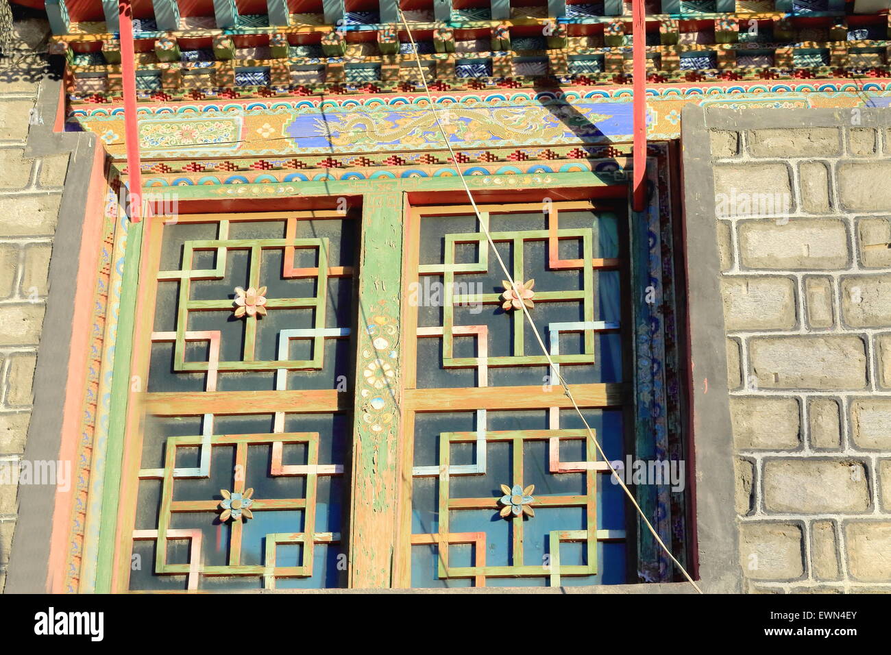 Profusely decorated carved many colored roof eaves and window of a ...