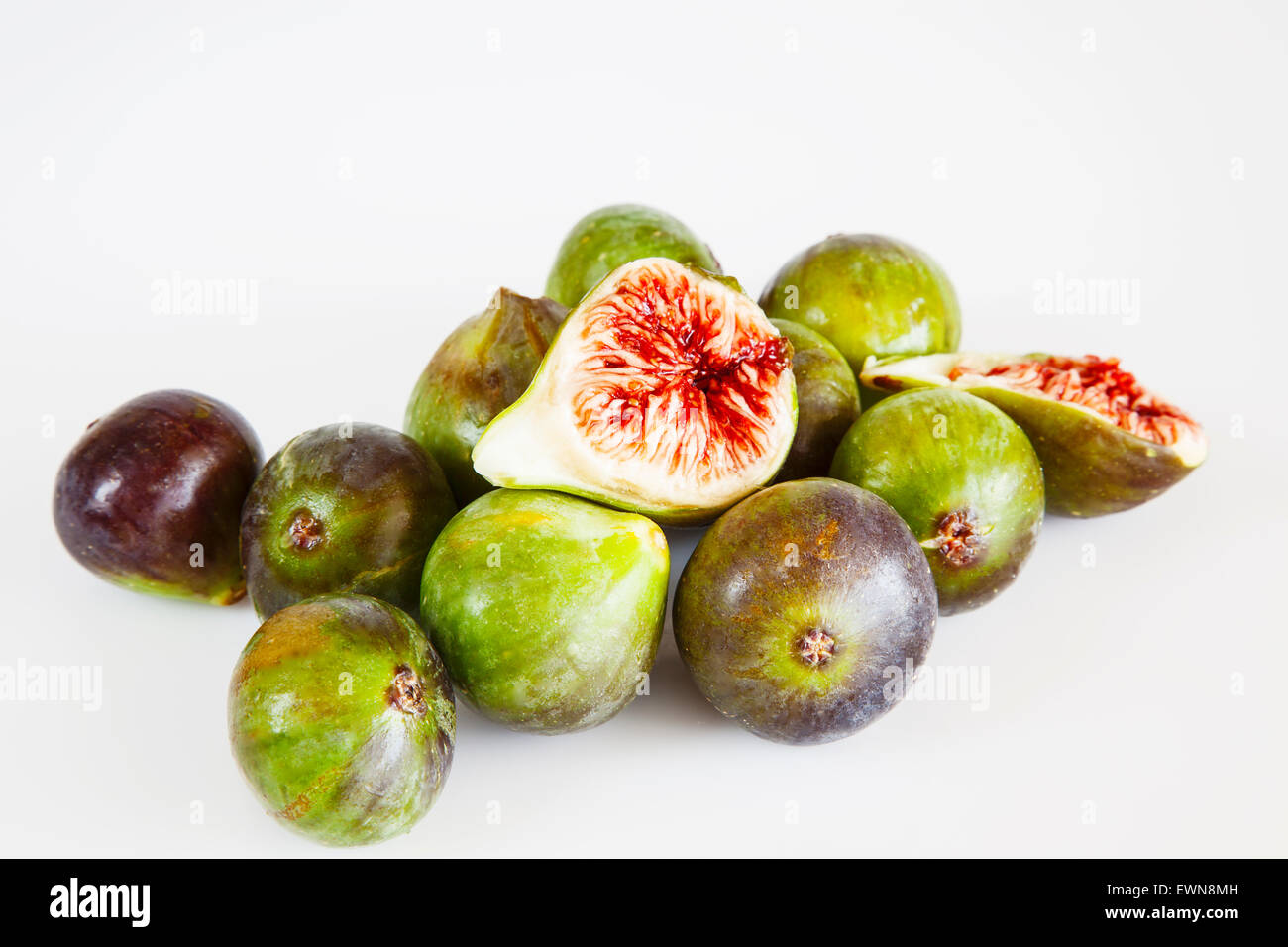 set of green figs on white background with some cut and open Stock ...