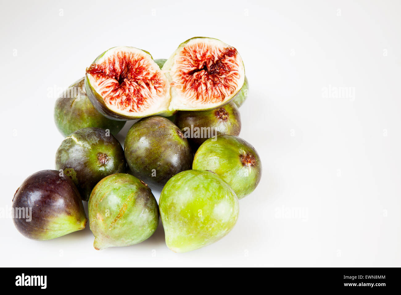 set of green figs on white background with some cut and open Stock ...