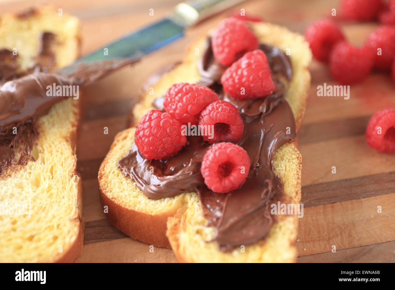 Putting together a tasty sandwich of fresh raspberries and chocolate ...