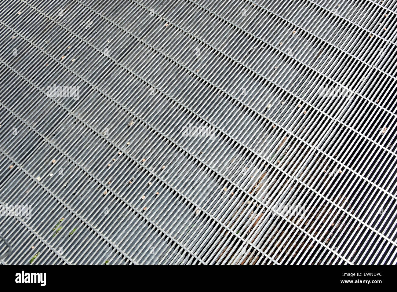A silver colored metal grate walkway Stock Photo - Alamy