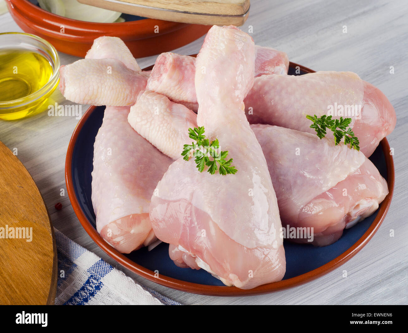Fresh raw chicken legs on a plate Stock Photo - Alamy