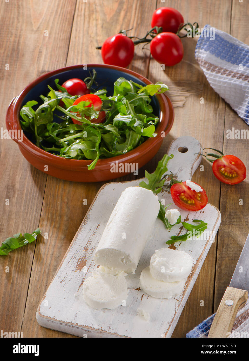 Goat cheese with fresh lettuce and tomatoes on a wooden table Stock ...