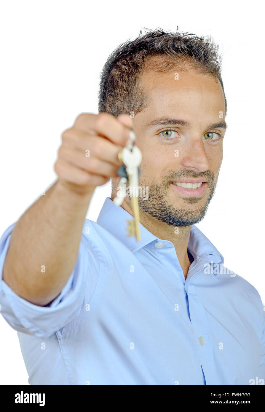 a young man shows house keys on white background Stock Photo - Alamy