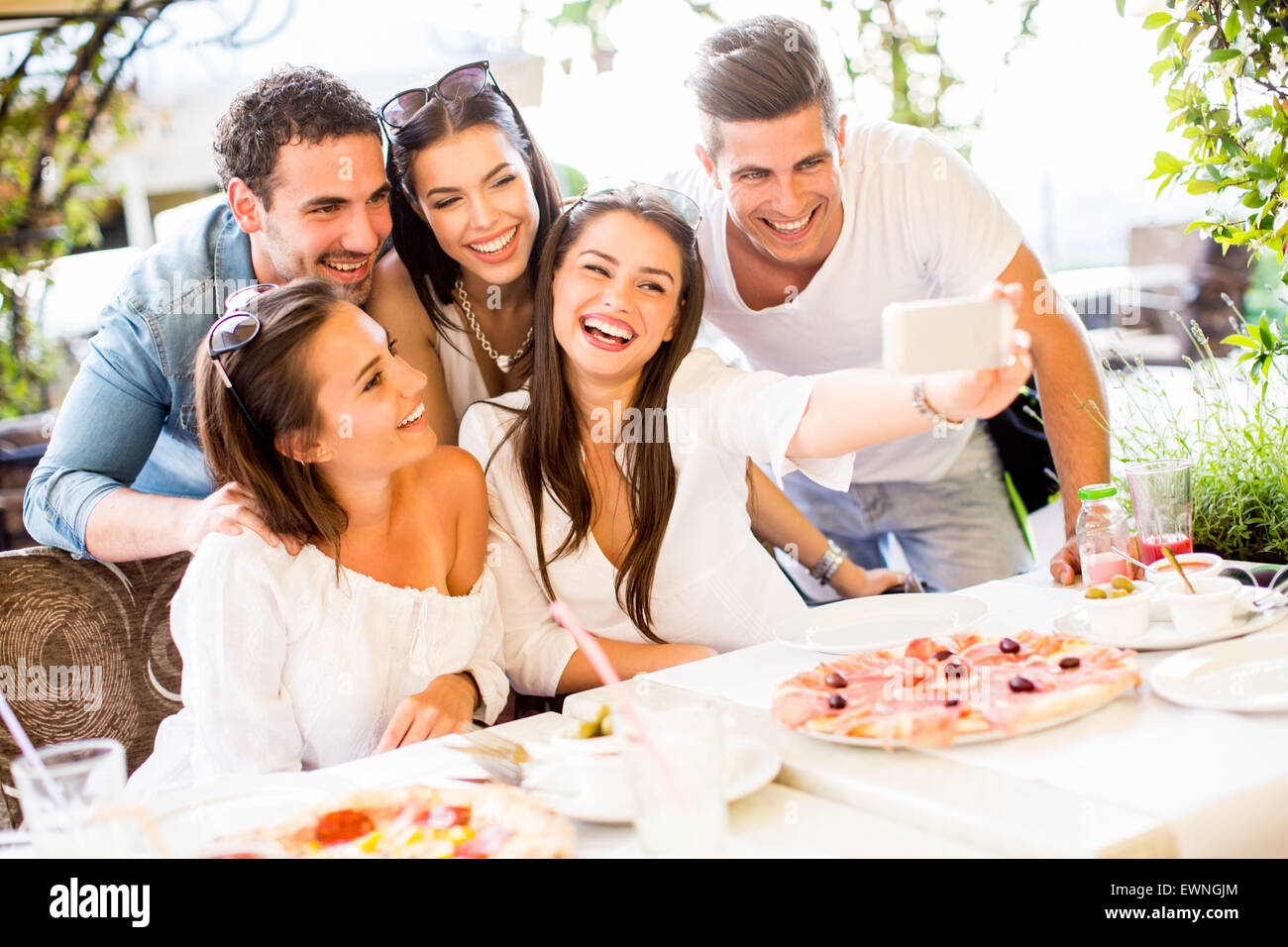 Young people taking photo by the table Stock Photo - Alamy