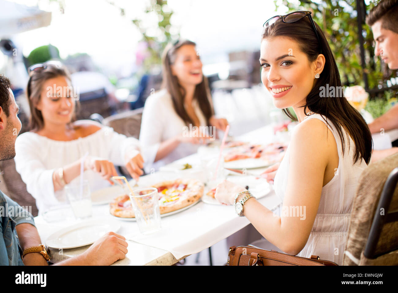 Young people by the table Stock Photo - Alamy