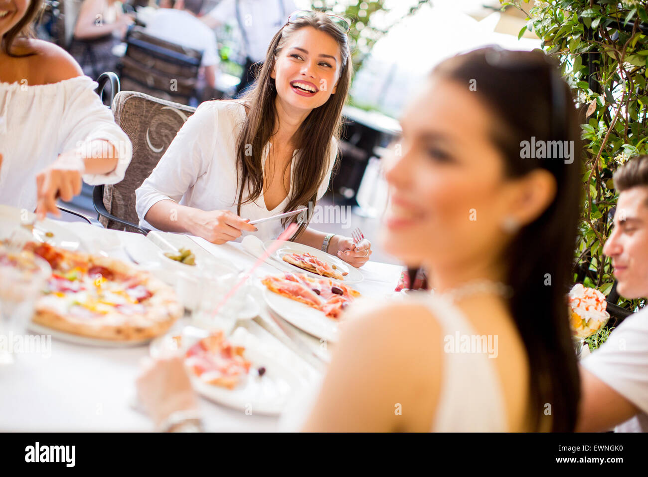 Young people by the table Stock Photo - Alamy
