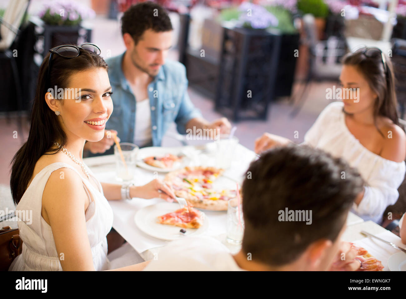 Young people by the table Stock Photo - Alamy