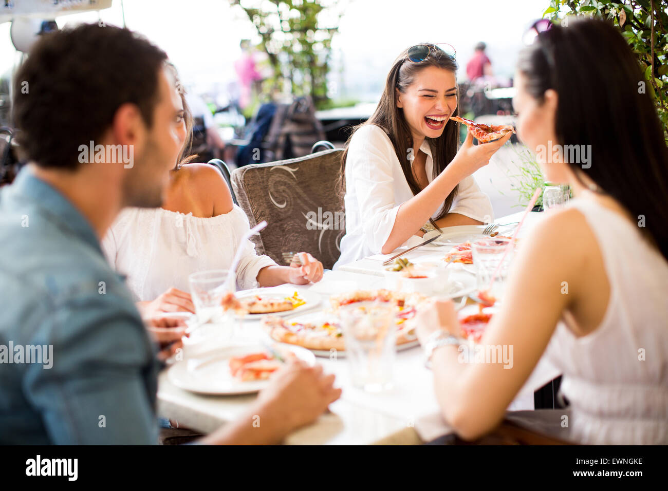 Young people by the table Stock Photo - Alamy