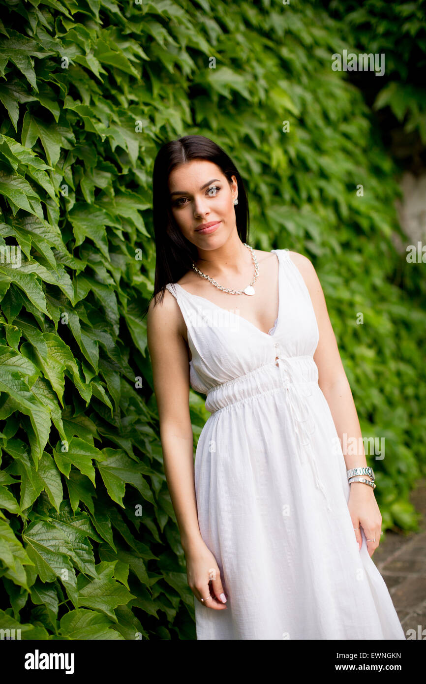 Young woman by the wall Stock Photo - Alamy