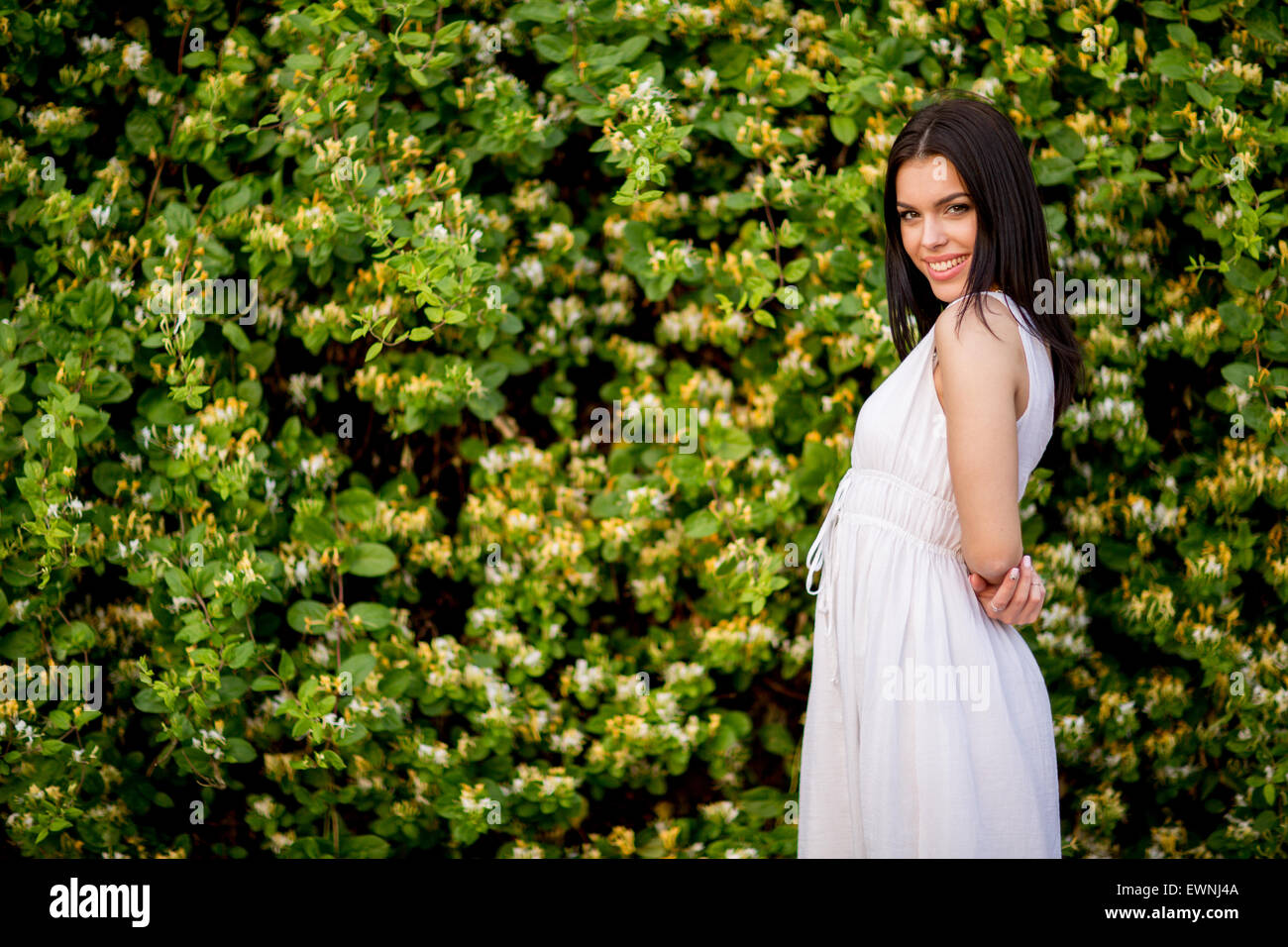 Young woman by the wall Stock Photo - Alamy