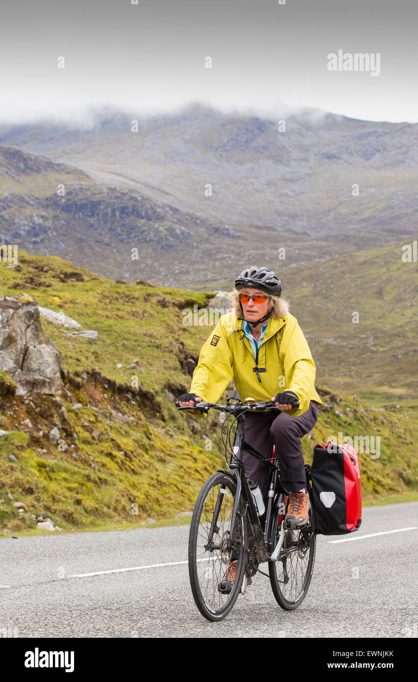 A woman cycle touring on the Isle of Harris, Outer Hebrides, Scotland ...