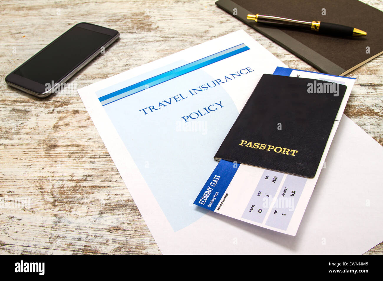 Travel insurance policy booklet with a boarding pass and a passport ...