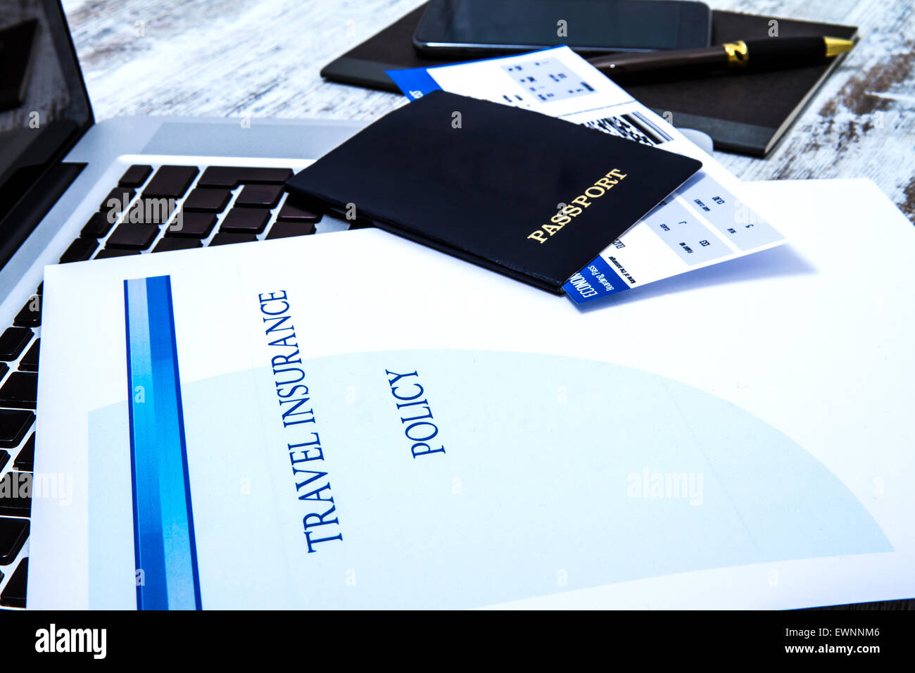 Travel insurance policy booklet with a boarding pass and a passport ...