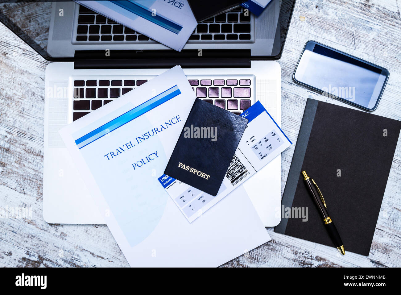 Travel insurance policy booklet with a boarding pass and a passport ...