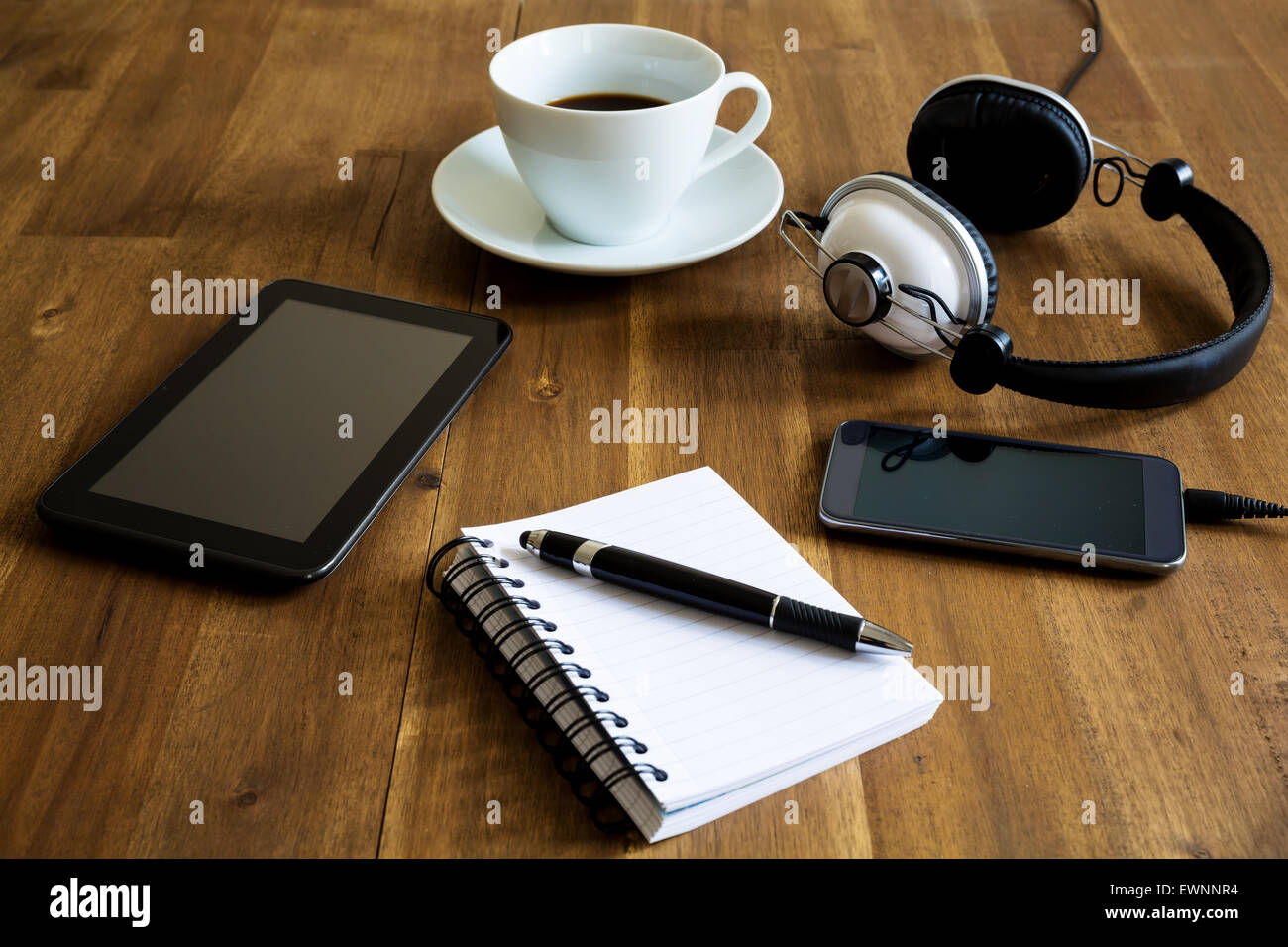 Working with the tablet, taking notes and drinking a coffee Stock Photo ...