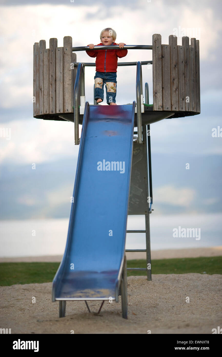 Little boy on slide hi-res stock photography and images - Alamy
