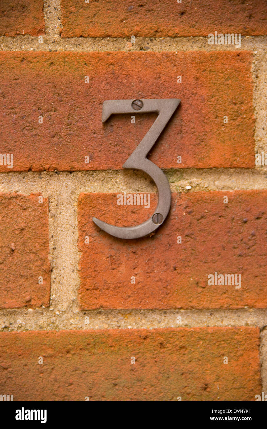 Number three house sign on red brick Stock Photo - Alamy