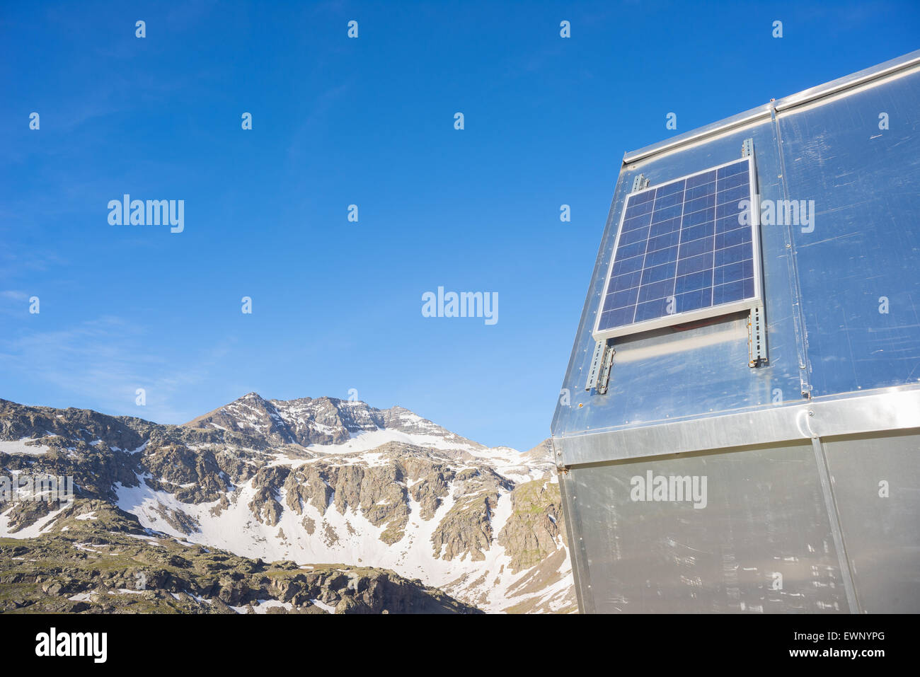 Solar panel installed on the roof of an alpine hut in an idyllic high ...