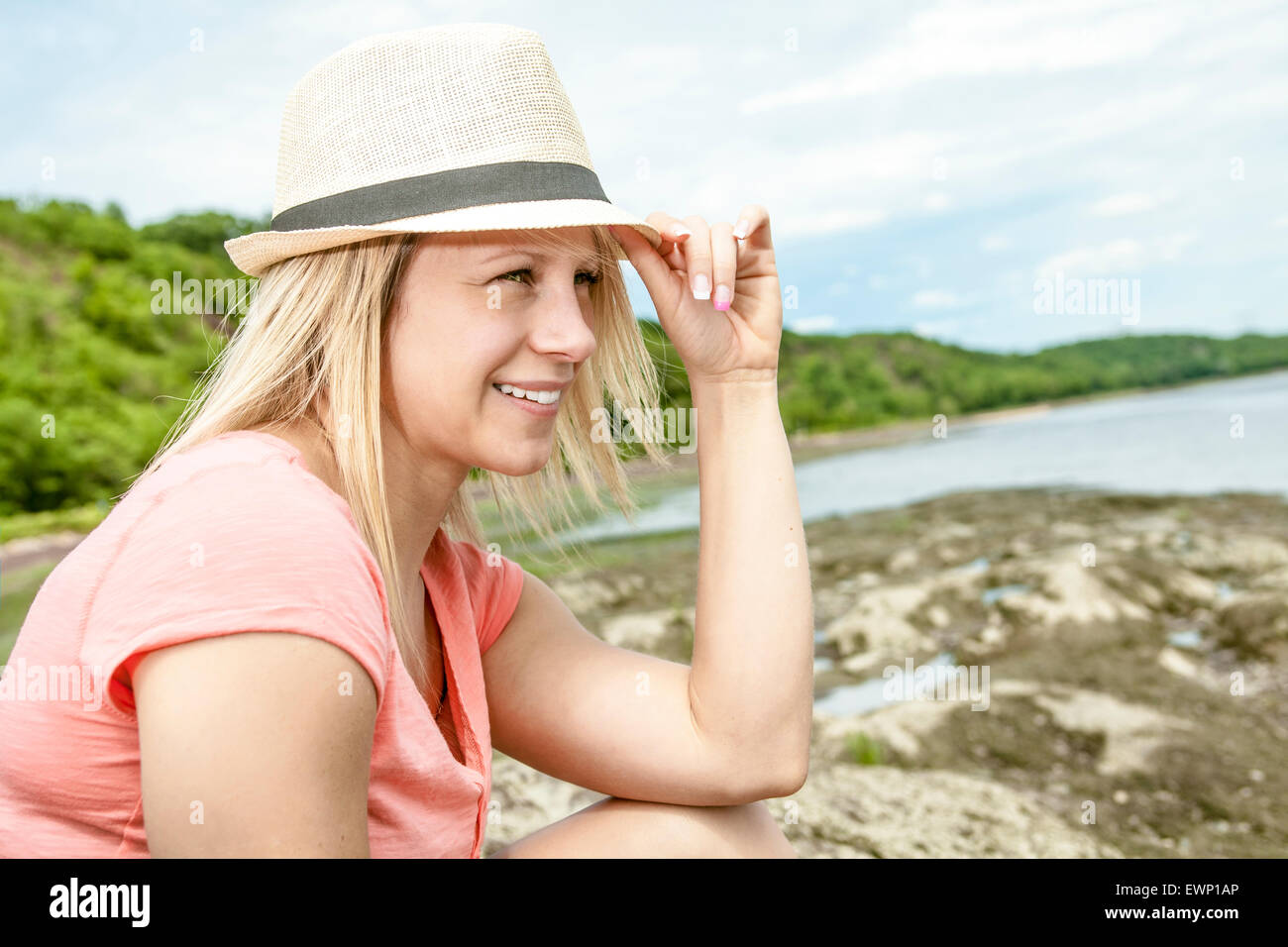 Woman on beach with hat Stock Photo - Alamy
