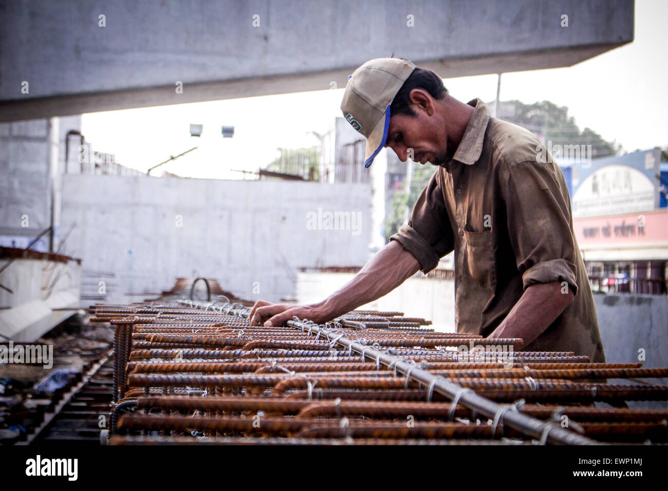 Dhaka, Bangladesh. 29th June, 2015. A construction worker working at ...