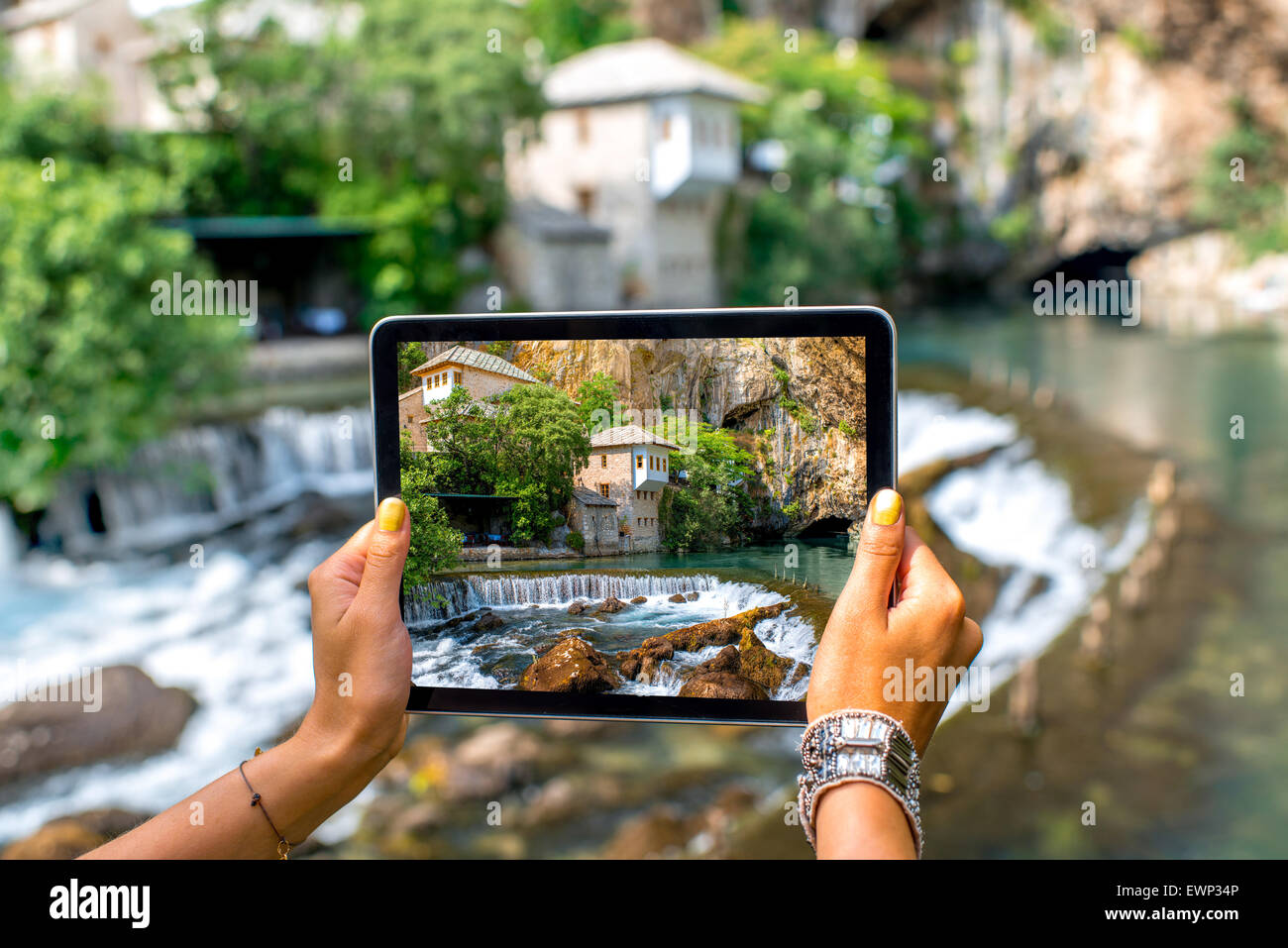 Woman photographing house on Buna spring in Blagaj village Stock Photo ...
