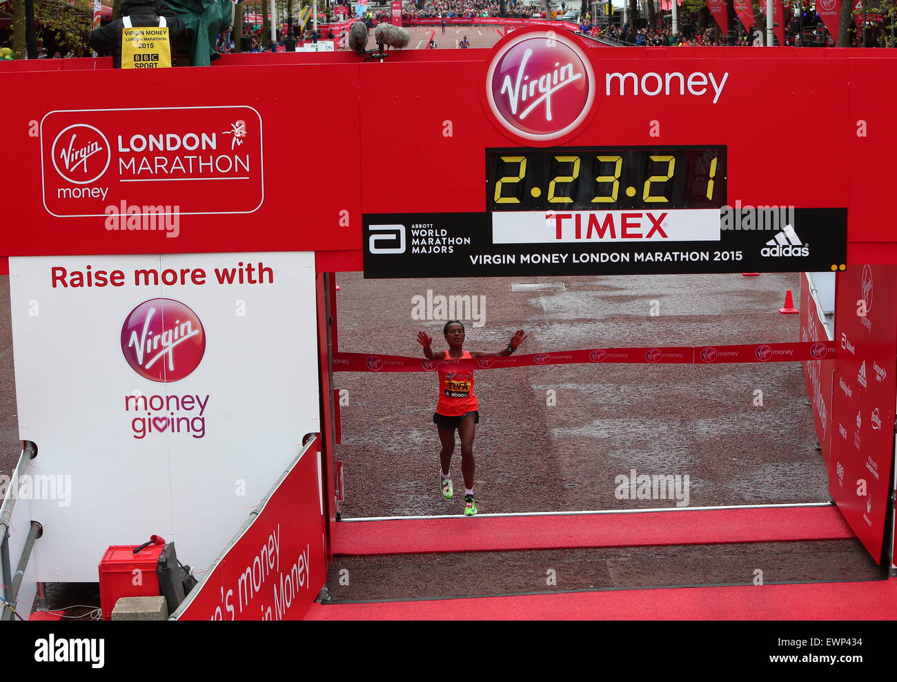 Runners cross the finish line in the Virgin Money London Marathon 2015 ...