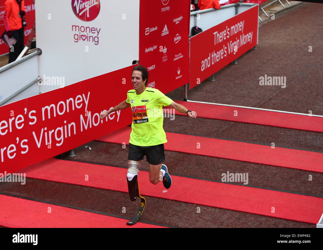 Runners cross the finish line in the Virgin Money London Marathon 2015 ...
