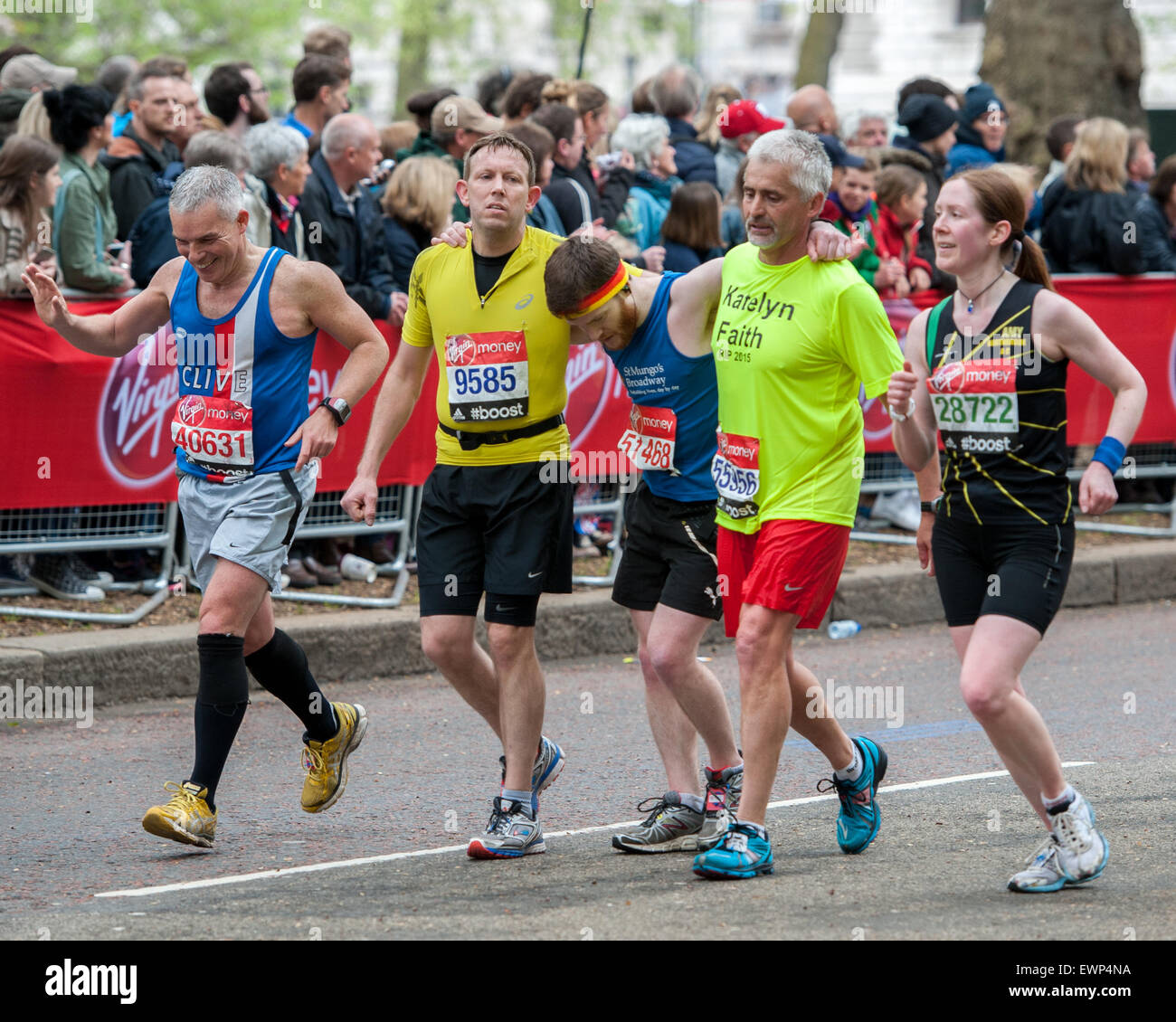 Runners in the London Marathon struggle in pain during the last ...