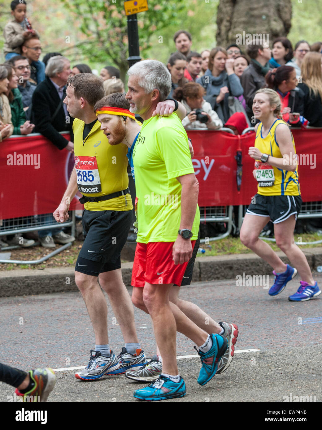 Runners in the London Marathon struggle in pain during the last ...
