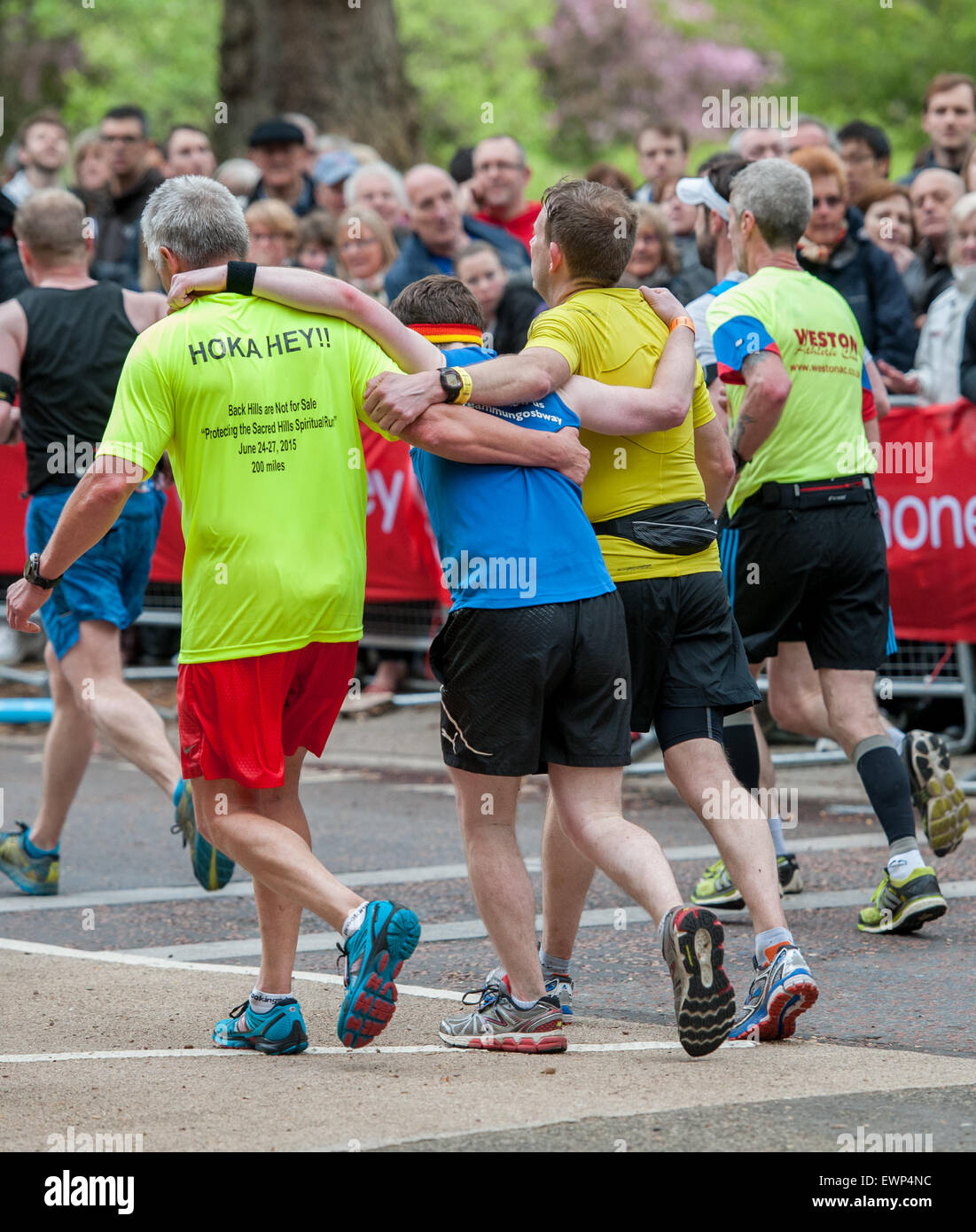 Runners in the London Marathon struggle in pain during the last ...