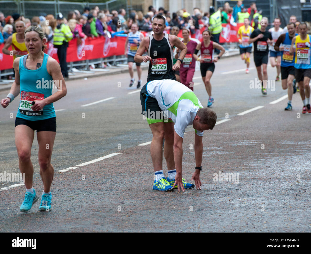 Runners in the London Marathon struggle in pain during the last ...