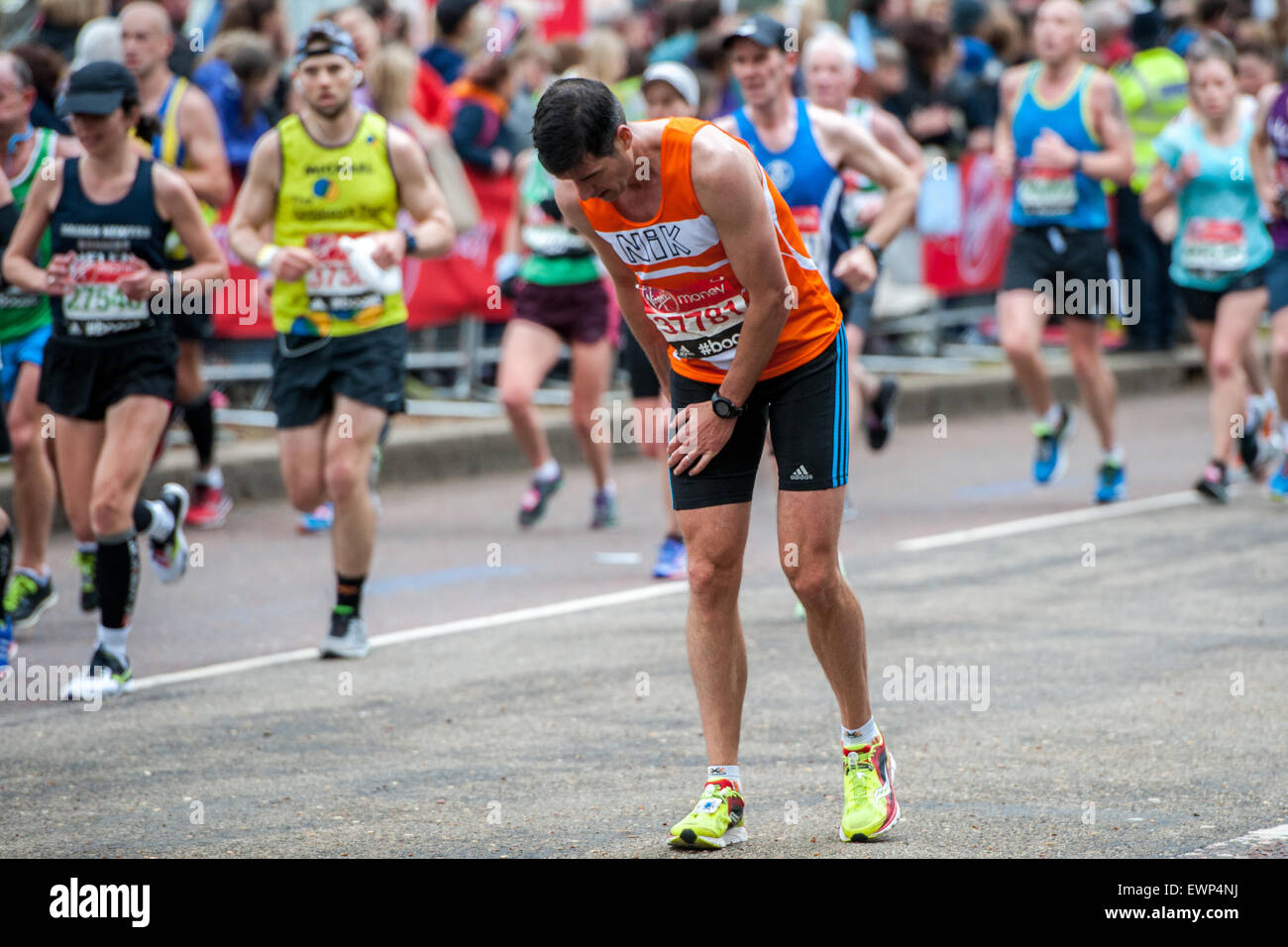 Runners in the London Marathon struggle in pain during the last ...