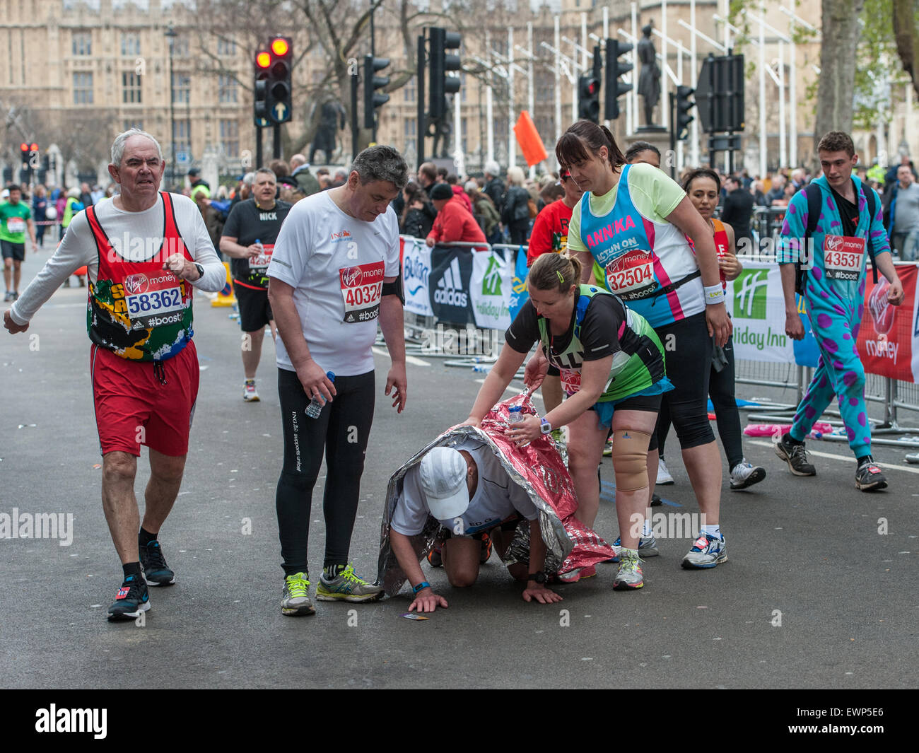 Runners in the London Marathon struggle in pain during the last ...