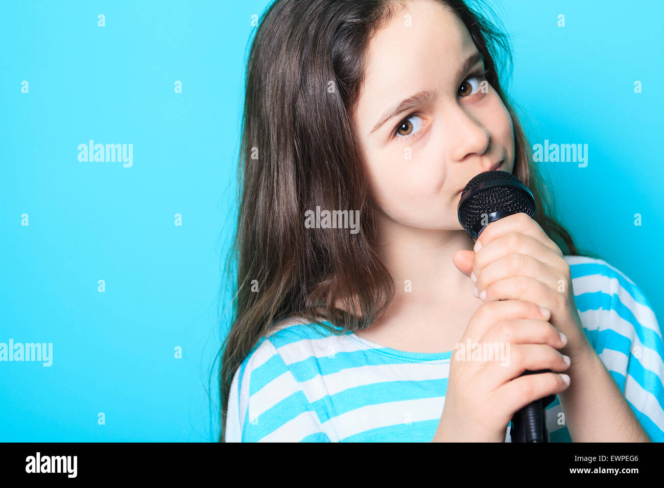 girl sing in a microphone Stock Photo - Alamy