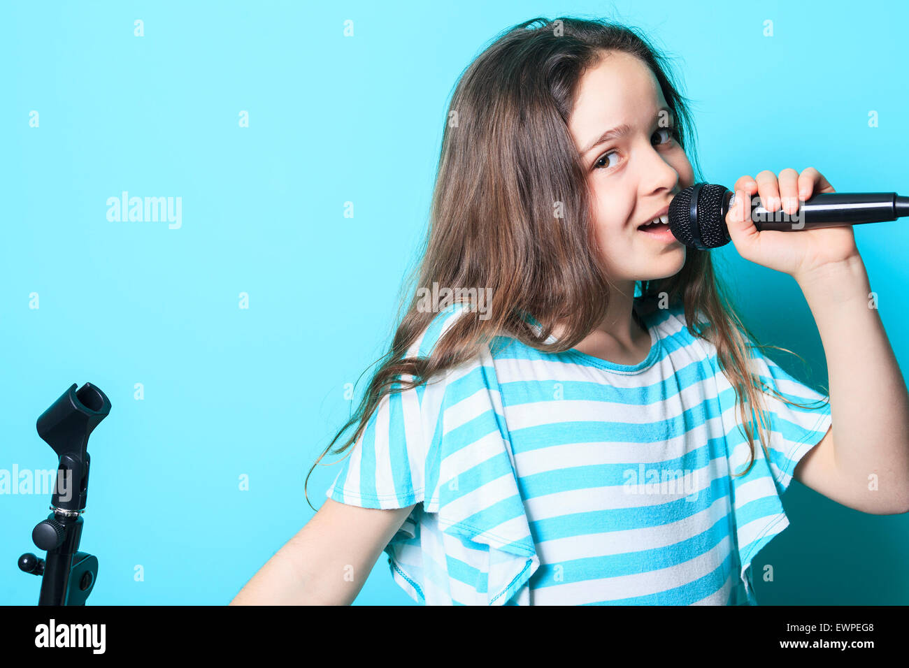 girl sing in a microphone Stock Photo - Alamy