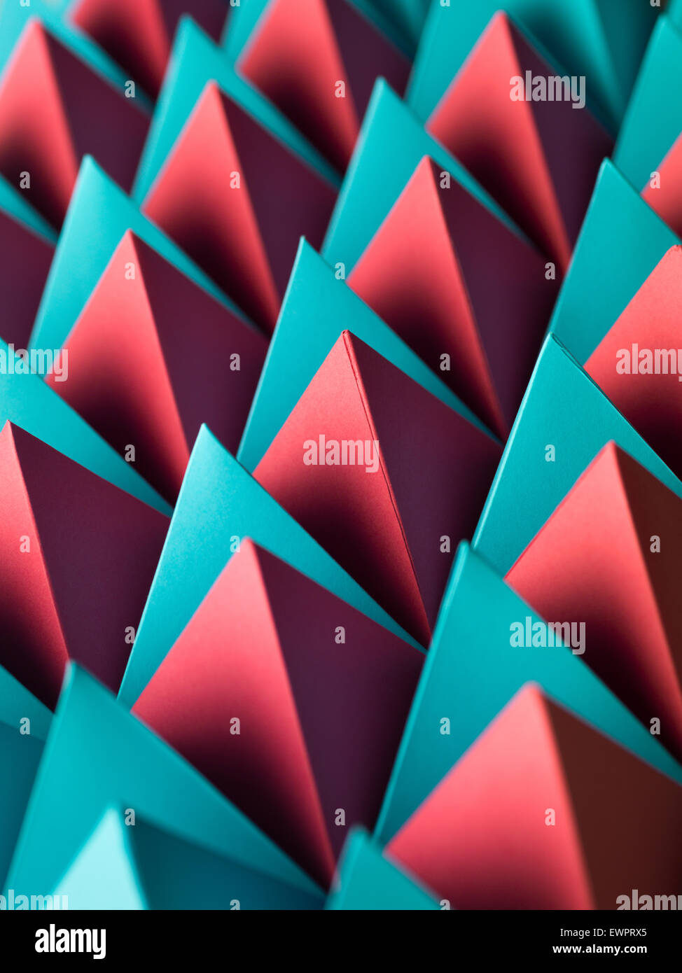 abstract geometrical background with colorful paper pyramids. selective ...