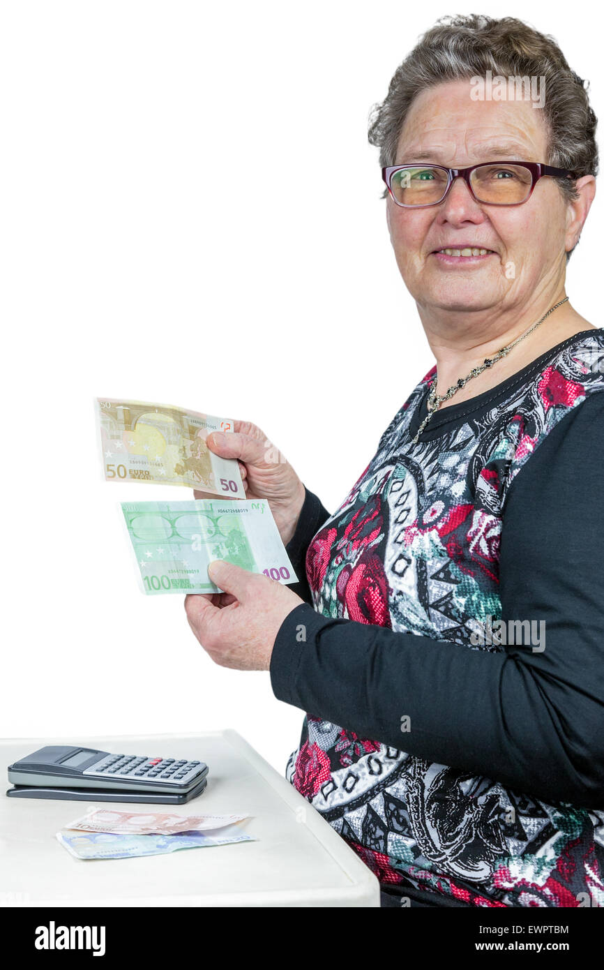 Senior caucasian woman counting and showing money with calculator ...