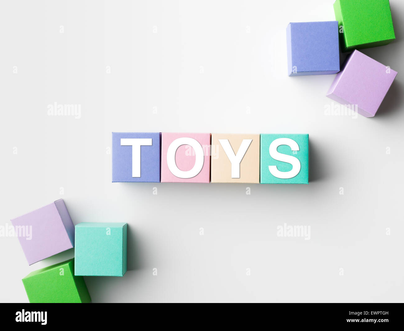 multicolored blocks with toys word written on them, on white background ...