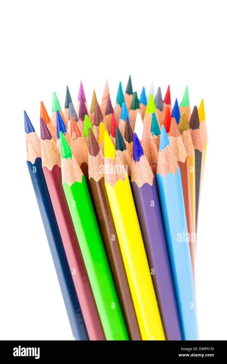 Various colered crayons standing upright isolated on white background ...