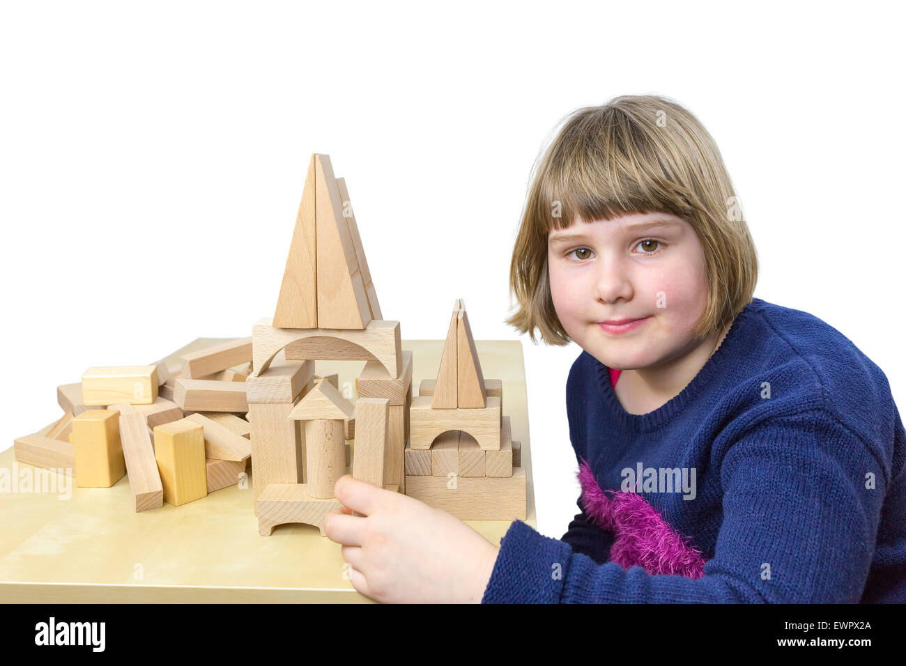 Young girl building construction with wooden blocks Stock Photo - Alamy