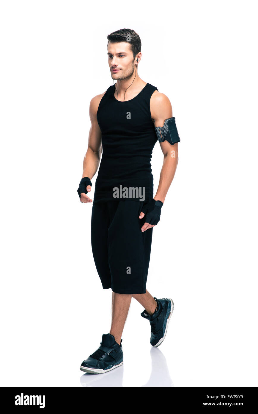Full length portrait of a fitness man walking isolated on a white ...