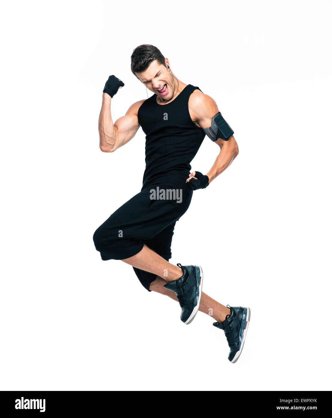 Full length portrait of a cheerful fitness man jumping isolated on a ...