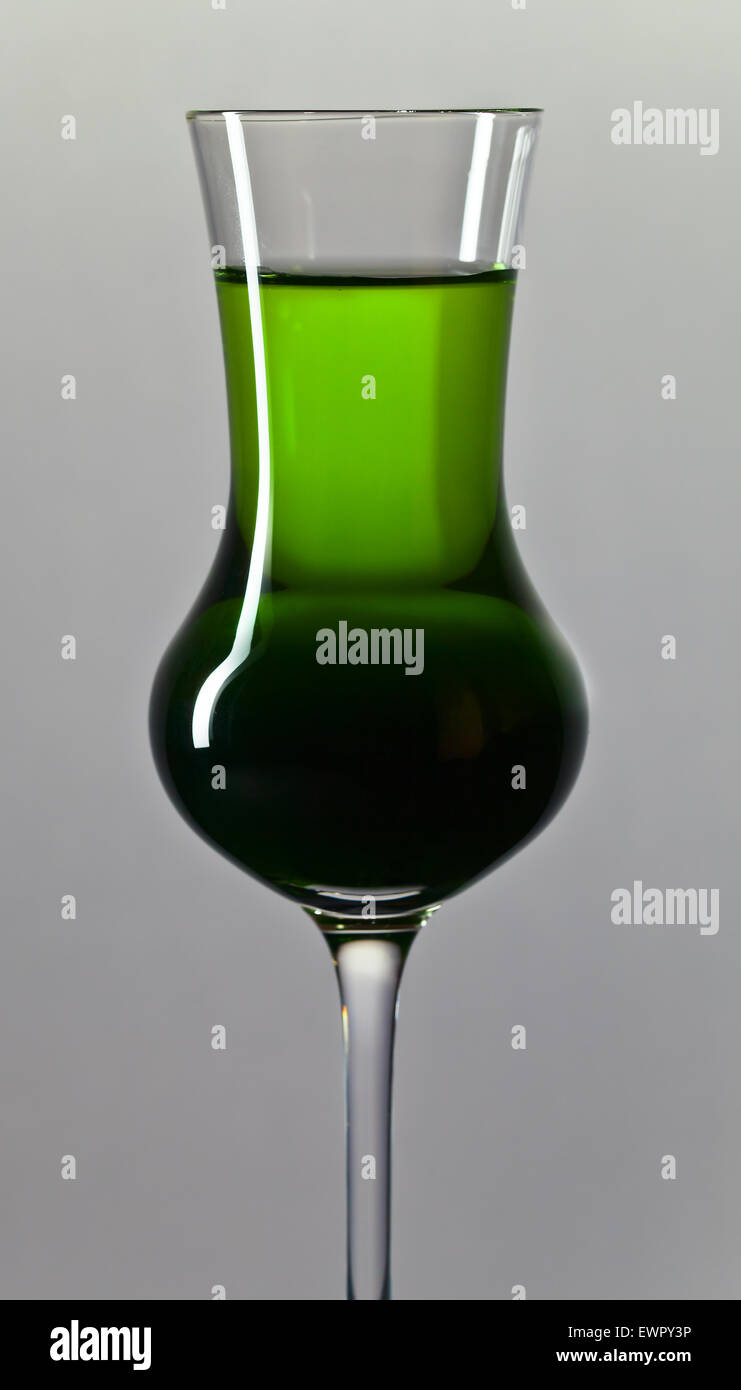 green alcoholic drink on a grey background Stock Photo - Alamy